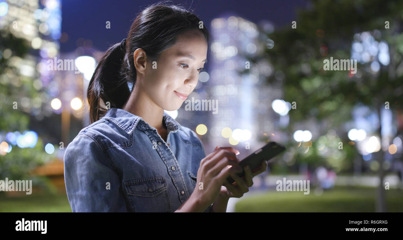 Young woman use of mobile phone in city of Hong Kong at night Stock ...