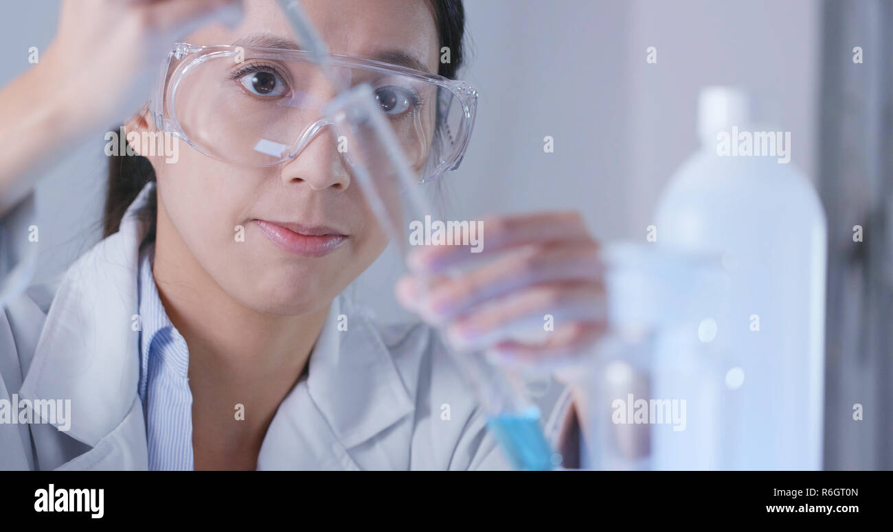 Female scientist observation about test tube Stock Photo - Alamy