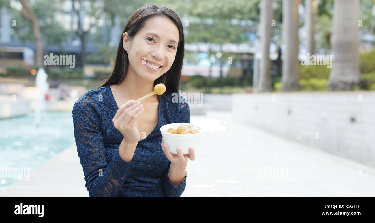 Woman eating fish ball in Hong Kong, famous street food Stock Photo - Alamy