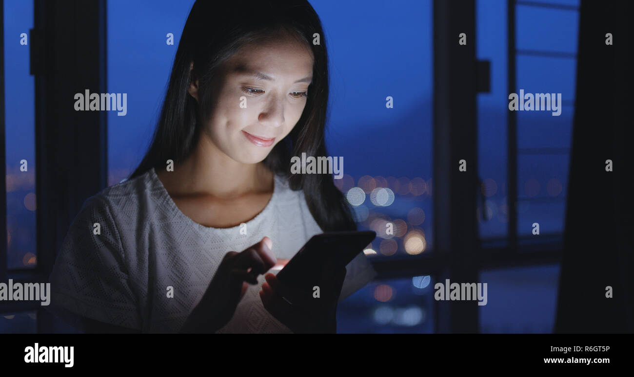 Woman use of mobile phone at night Stock Photo - Alamy