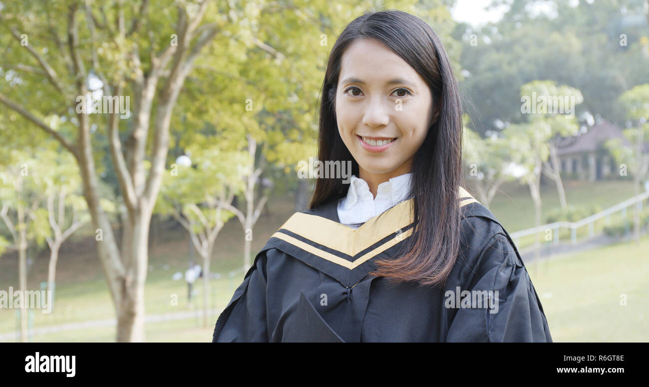 Young woman get graduation over green background Stock Photo - Alamy