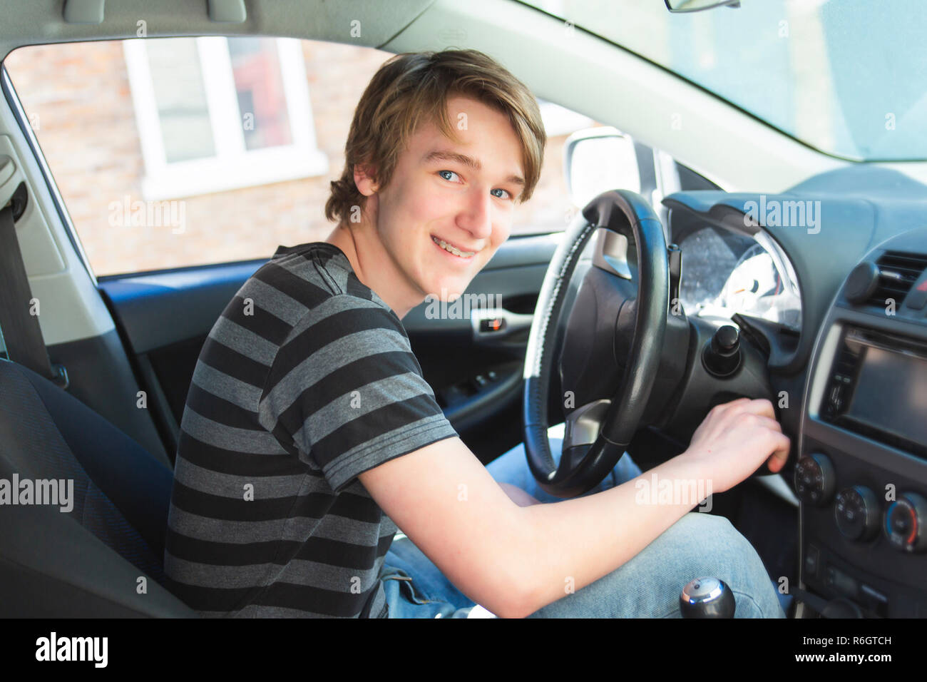 Teenage boy and new driver behind wheel of his car Stock Photo - Alamy