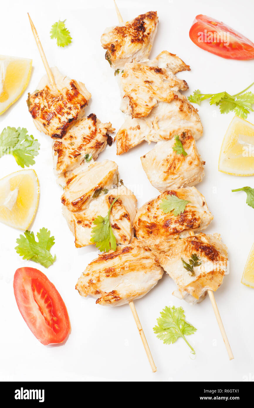 grilled chicken spit with cilantro Stock Photo - Alamy