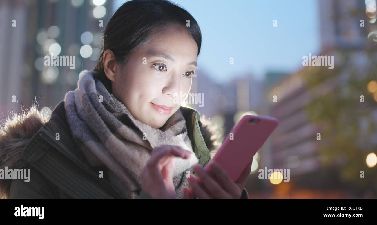 Woman use of mobile phone at night Stock Photo - Alamy