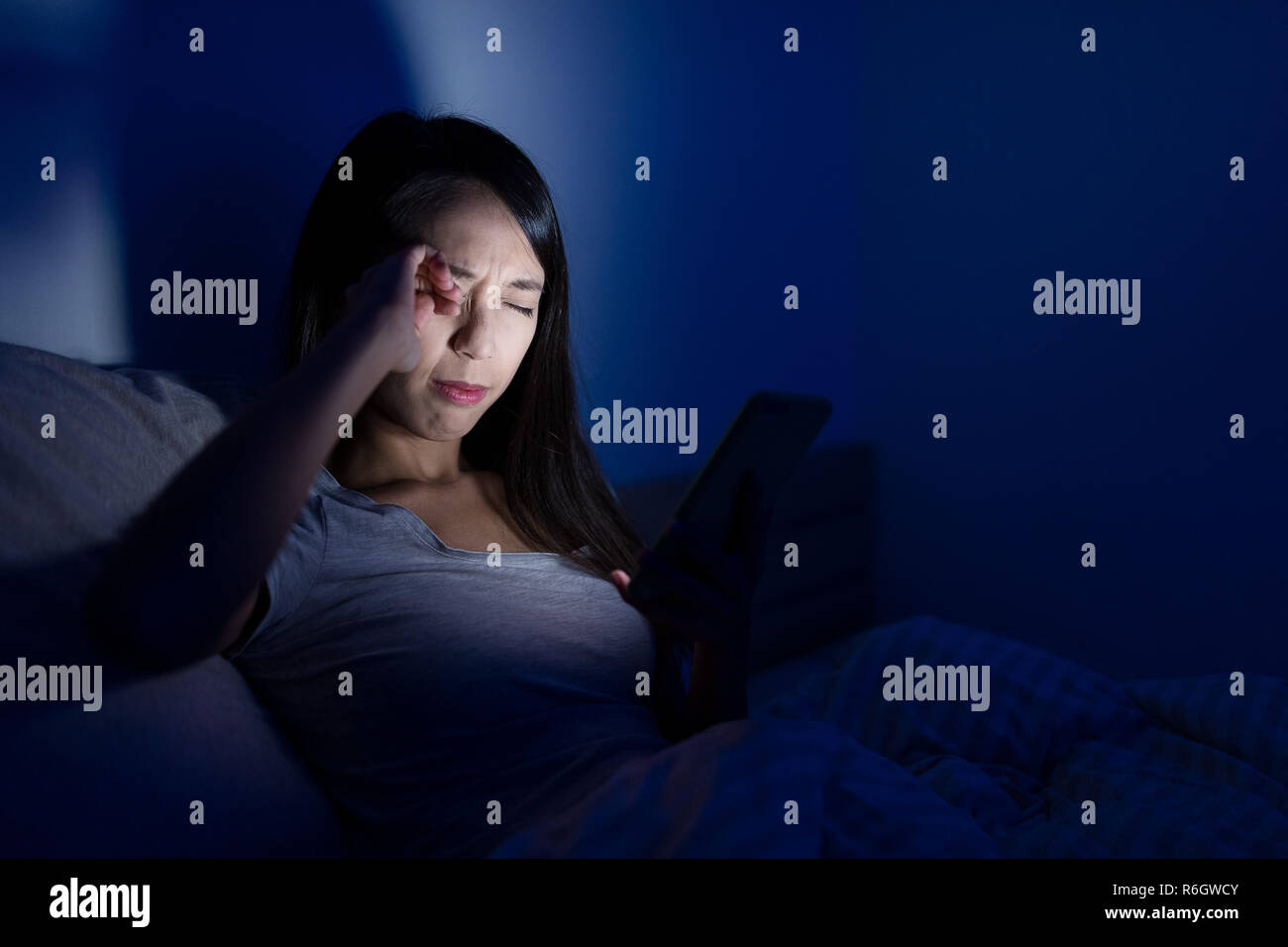 Woman suffer from headache with using cellphone at night Stock Photo ...