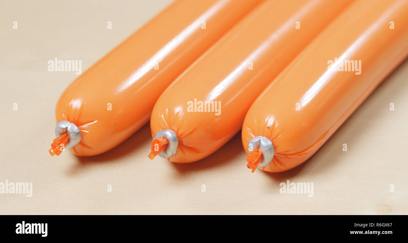 Snack sausage with plastic wrapping Stock Photo - Alamy