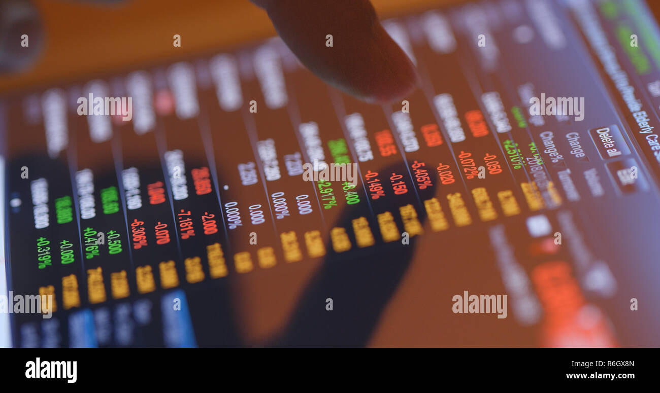 Finger touch on stock market data Stock Photo - Alamy