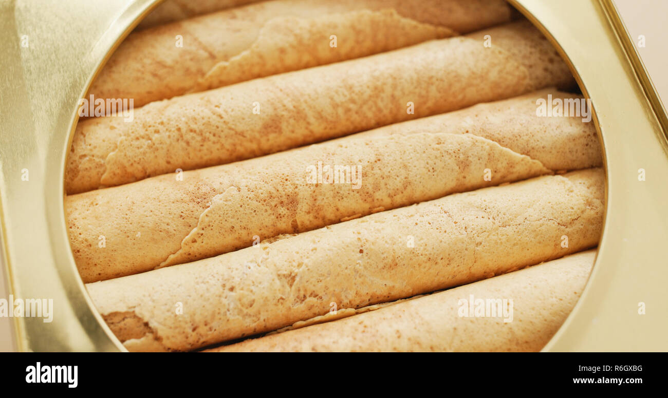 Waffle egg roll inside metal tin can Stock Photo - Alamy