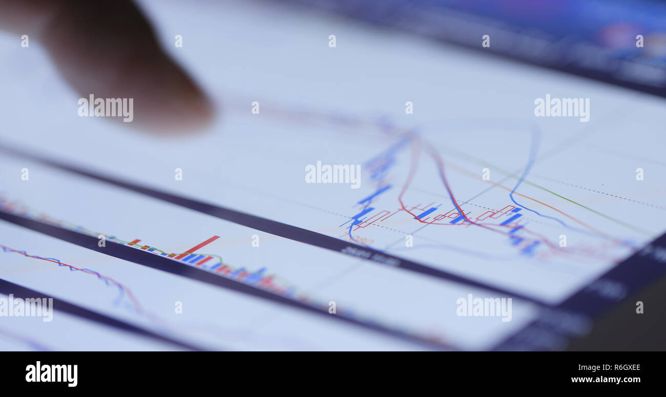 Finger touch on stock market data Stock Photo - Alamy