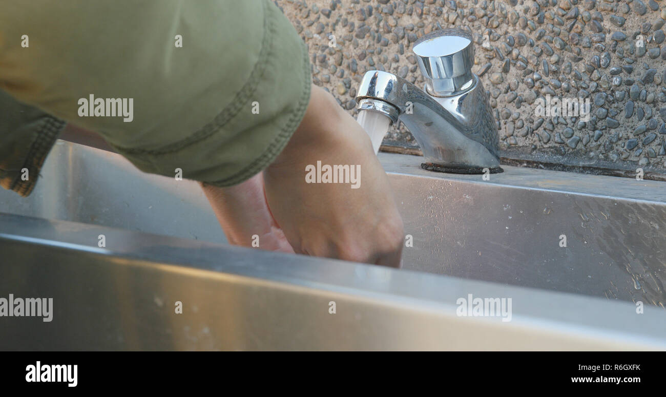Washing hands in a public toilet Stock Photo - Alamy