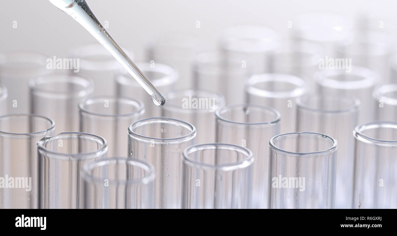 Pipette dropping the liquid into test tube Stock Photo - Alamy
