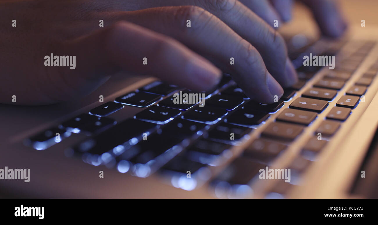 Hands typing on a laptop keyboard Stock Photo - Alamy
