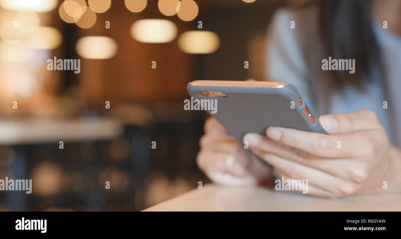Using smart phone in coffee shop Stock Photo - Alamy