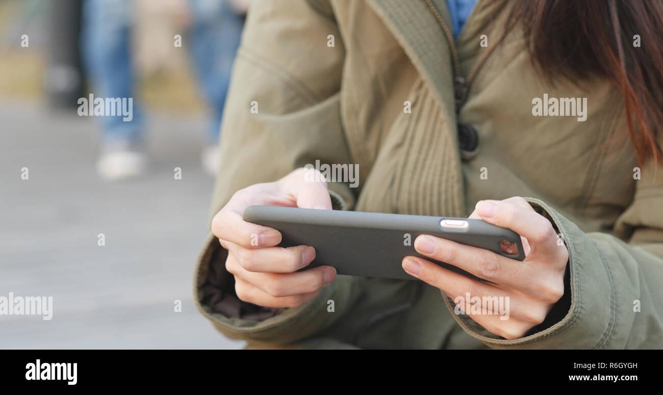 Playing mobile game on cellphone Stock Photo - Alamy