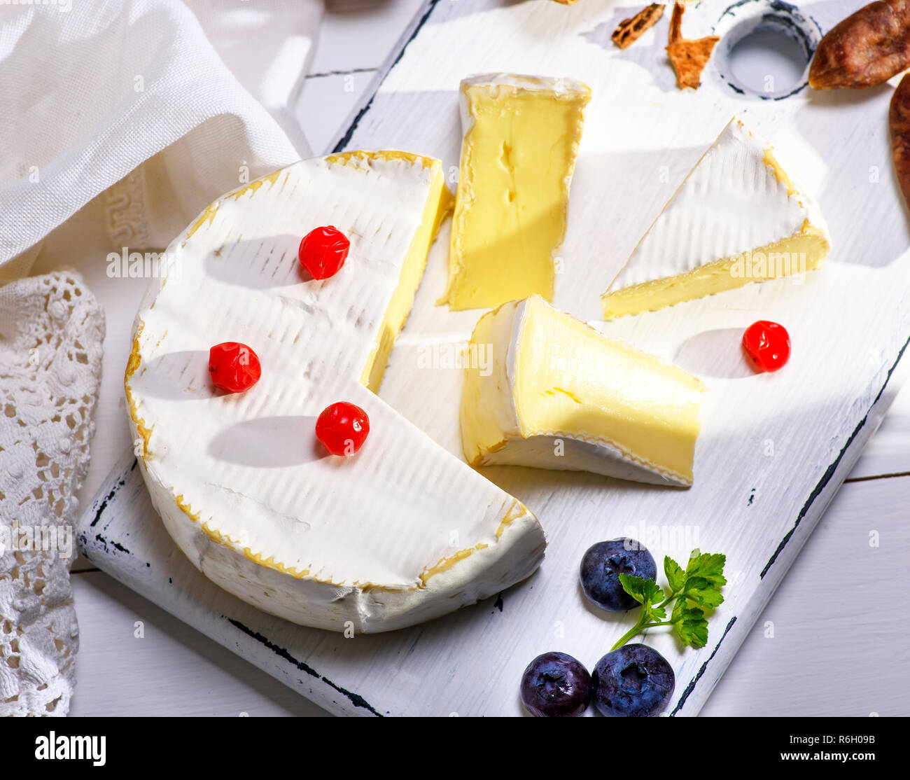 round Camembert cheese sliced Stock Photo - Alamy
