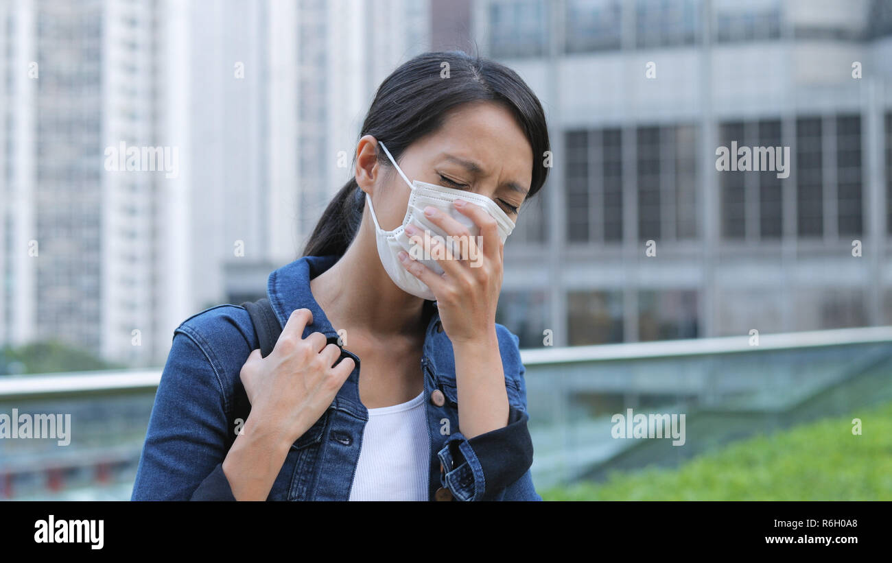 Woman sneeze and cough on face mask Stock Photo - Alamy