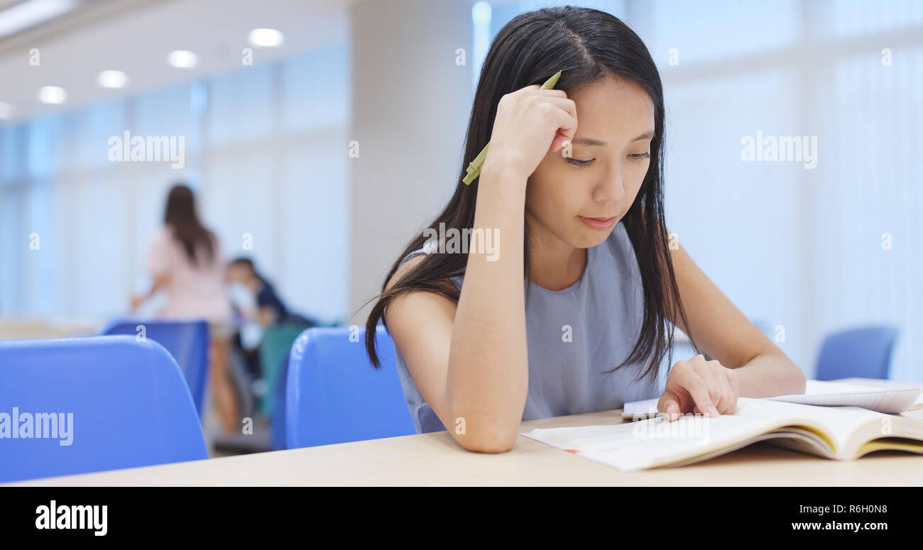 Student doing homework in university campus Stock Photo - Alamy