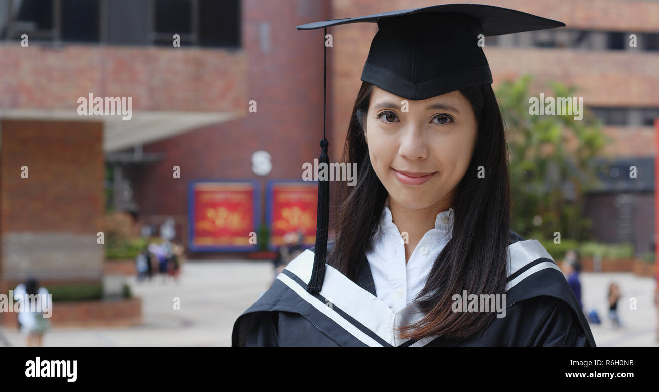 Graduation woman arm cross with wear graduation gown Stock Photo - Alamy
