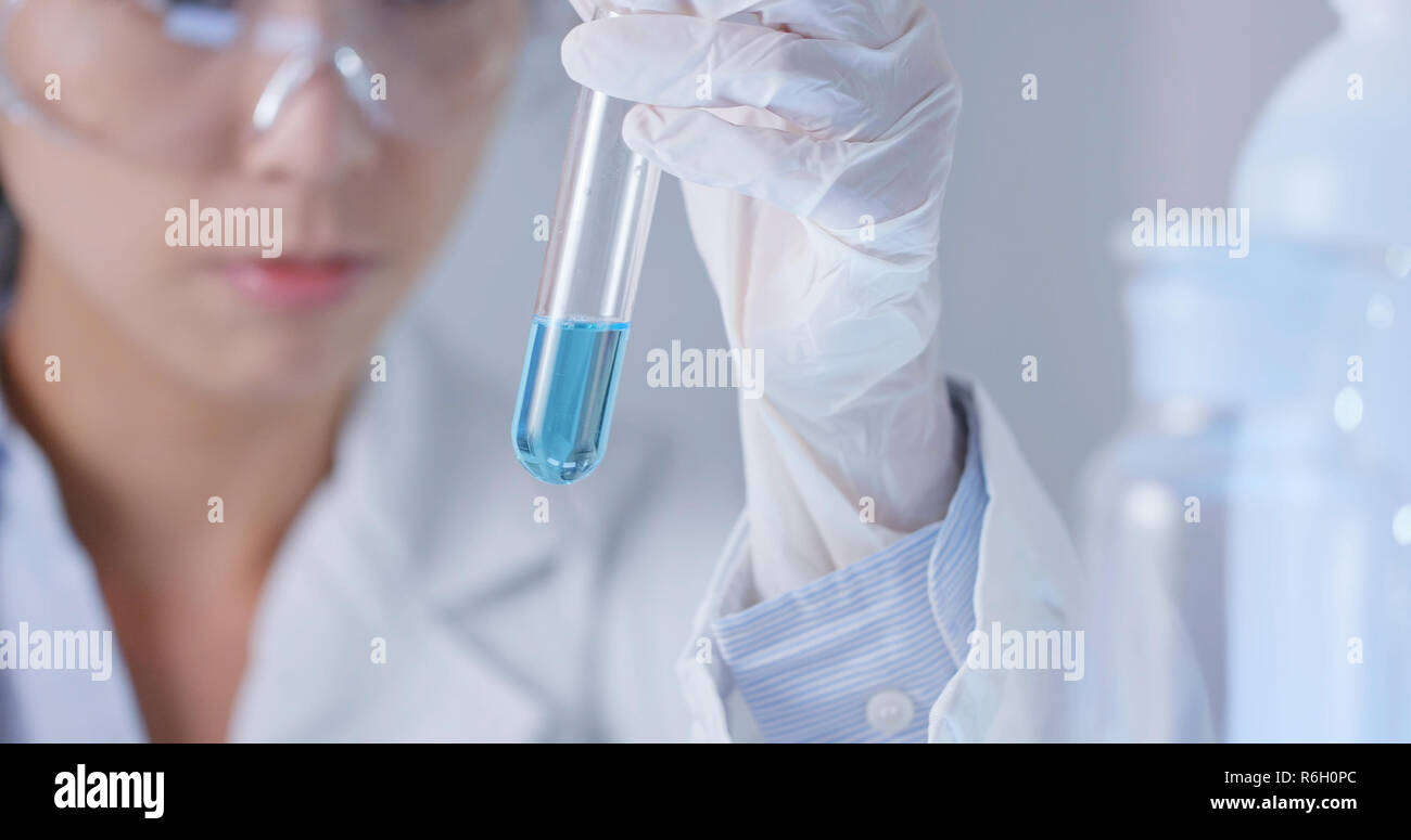 Laboratory technician observation on test tube Stock Photo - Alamy