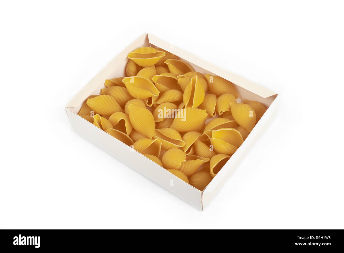 uncooked conchiglioni pasta shells in box , isolated on a white ...