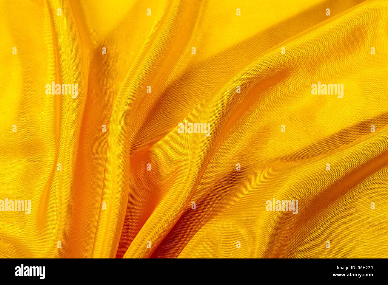 Silk background, texture of yellow shiny fabric Stock Photo - Alamy