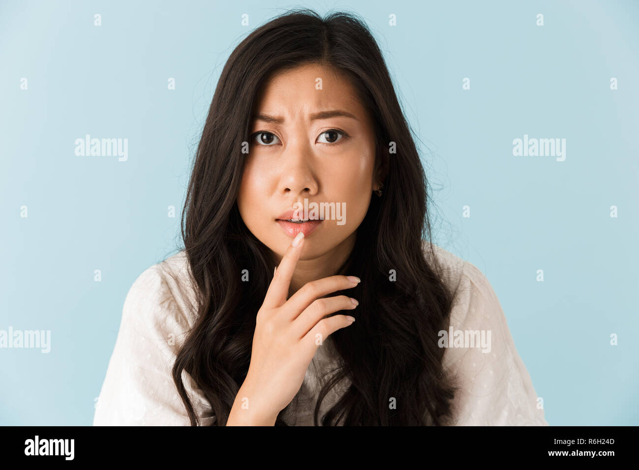 Image of thinking scared young asian beautiful woman posing isolated ...