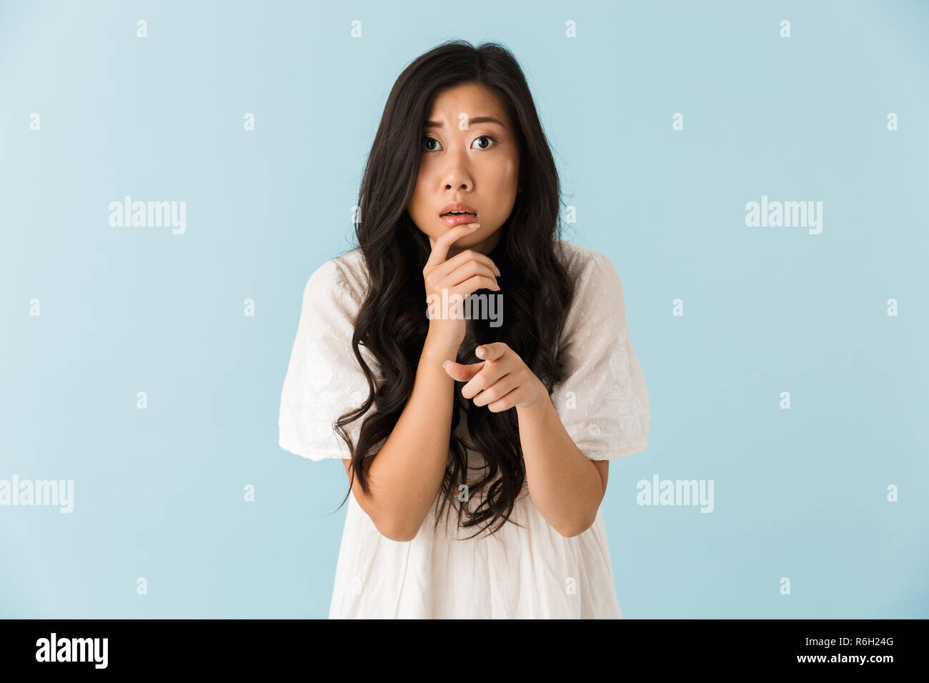 Image of thinking scared young asian beautiful woman posing isolated ...
