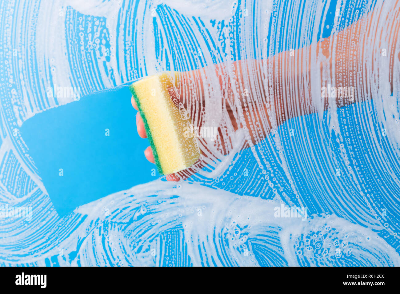 Hand cleaning glass window pane with detergent by sponge Stock Photo ...