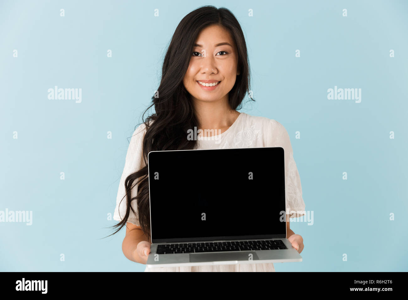 Image of young happy asian beautiful woman isolated over blue ...