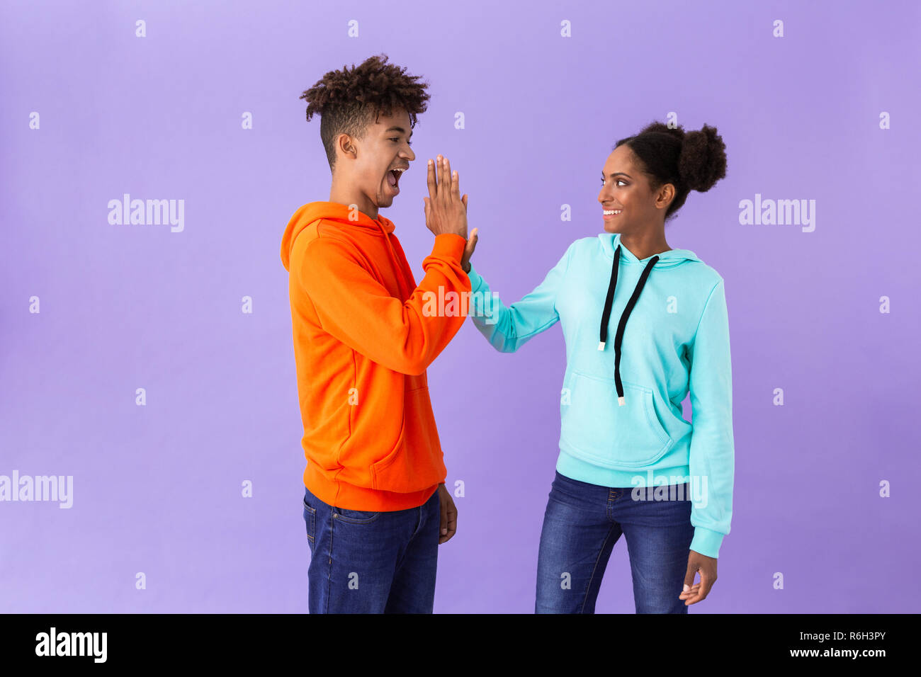 Photo of african american man and woman in colorful clothes smiling and ...