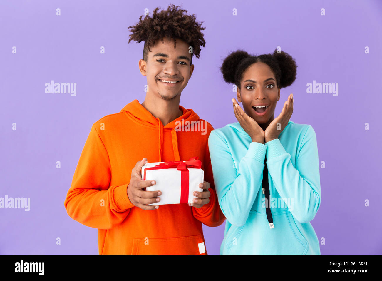 Photo of african american man smiling while giving present box to his ...
