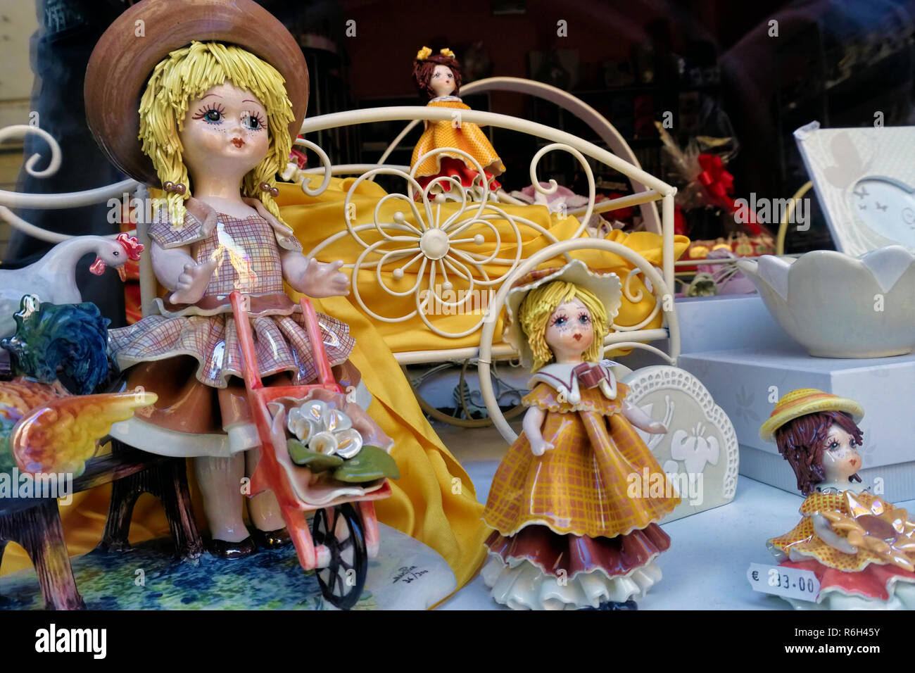 Four colourful dolls in a window display of a shop in Verona, Northern ...