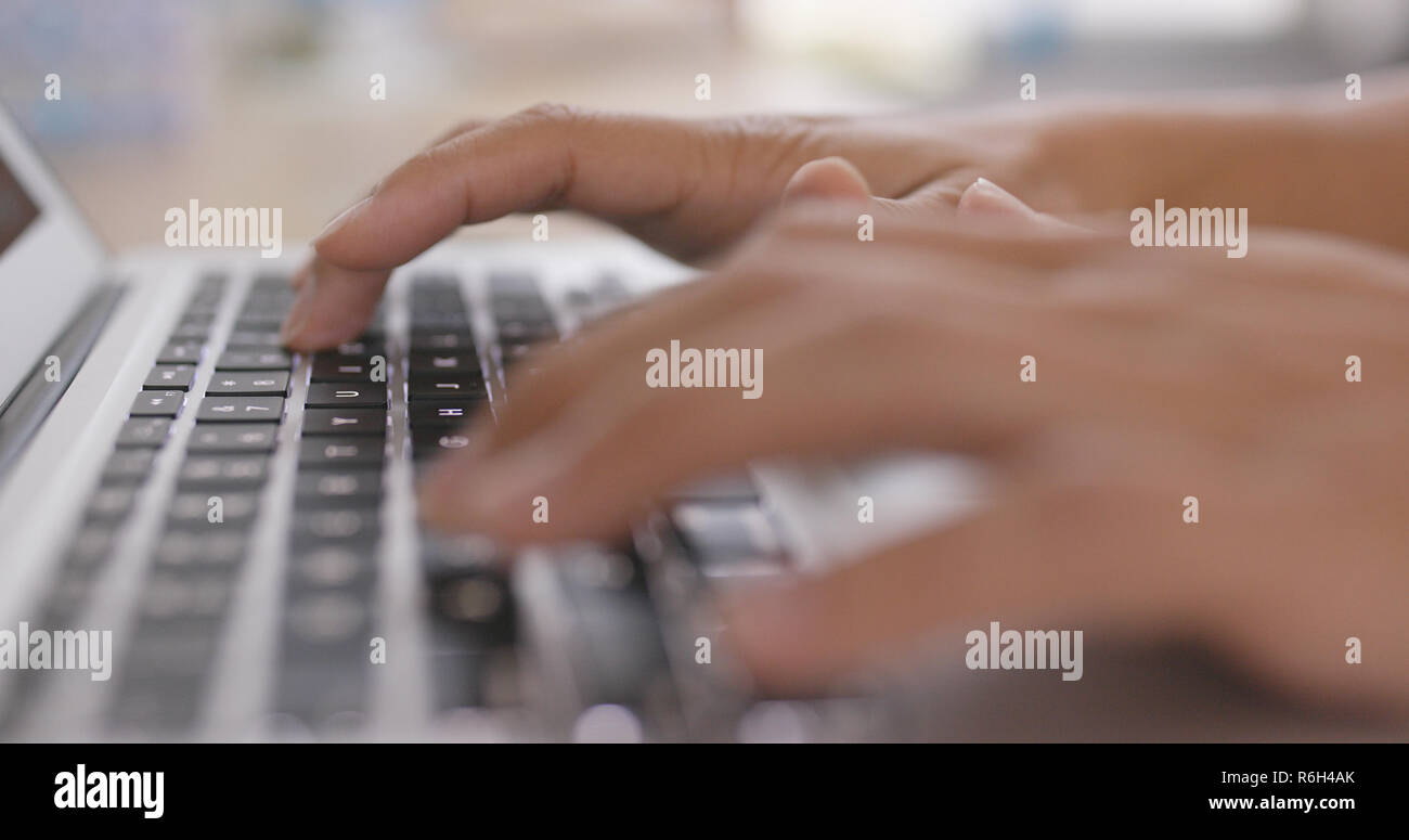 Typing on notebook computer Stock Photo - Alamy