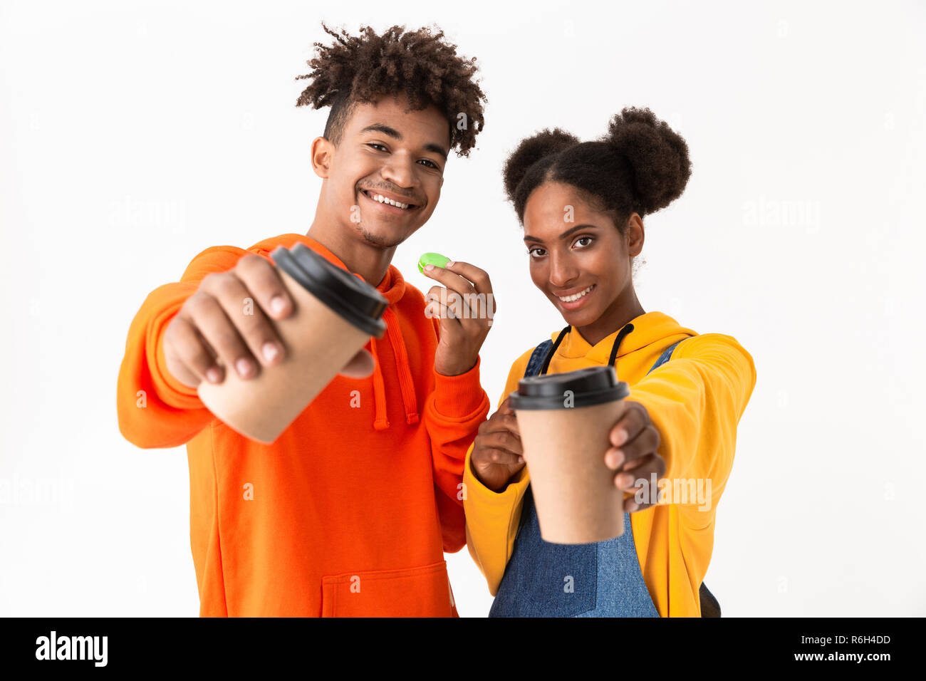 Photo of african american people in colorful clothes eating macaroon ...