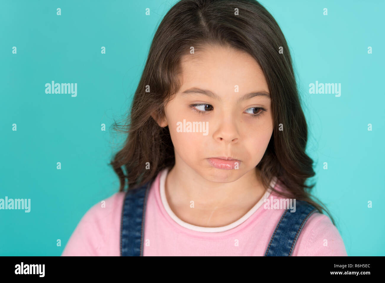 Pursed her mouth. Unhappy little girl. Small child with sad look. Small ...