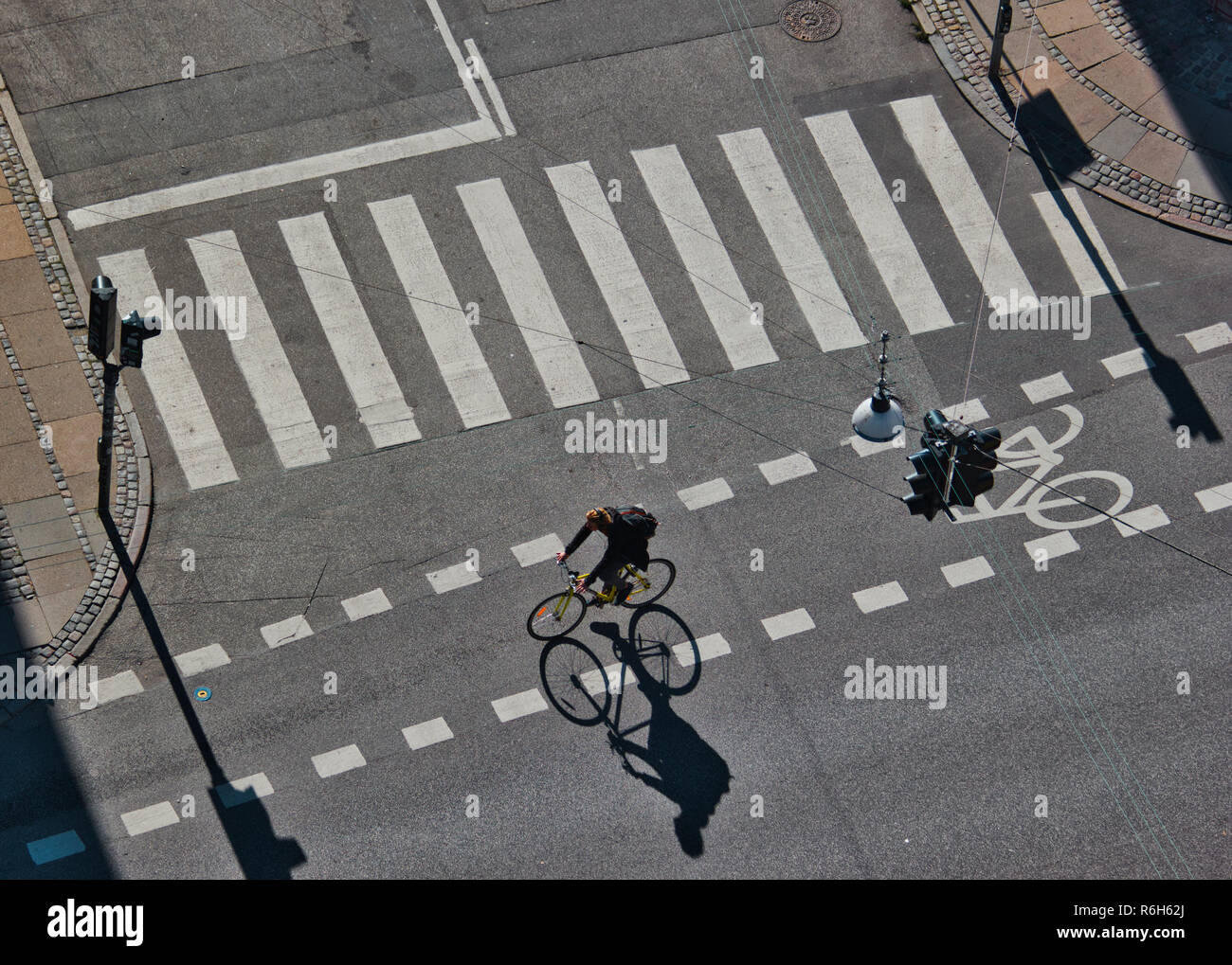 High angle shot of cyclist and shadow on cycle path, Christianshavn ...