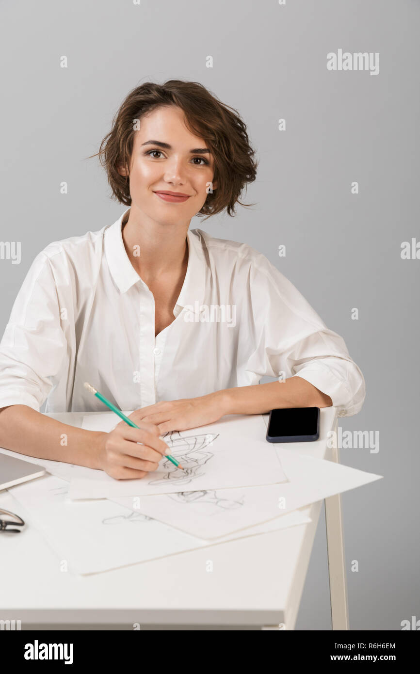 Image of young business woman posing isolated over grey wall background ...