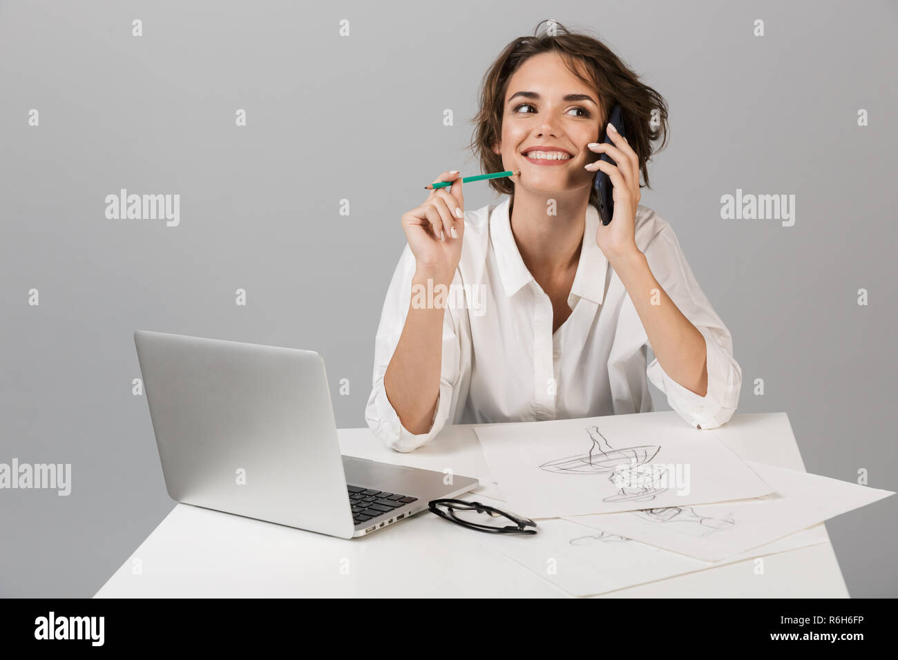 Image of young business woman posing isolated over grey wall background ...