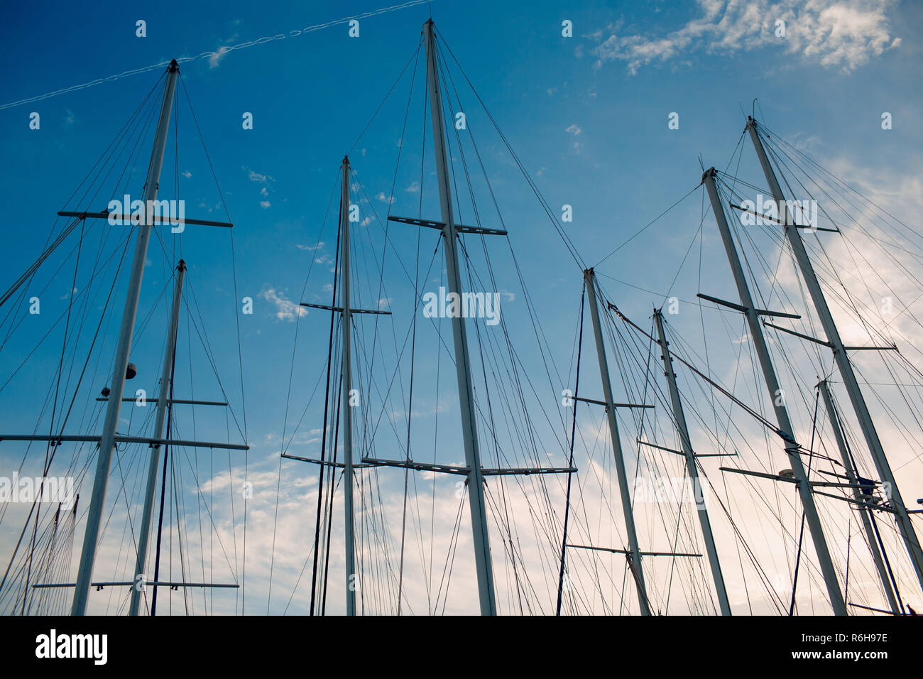 The masts of the sea yacht at the pier, illuminated by the sun Stock ...