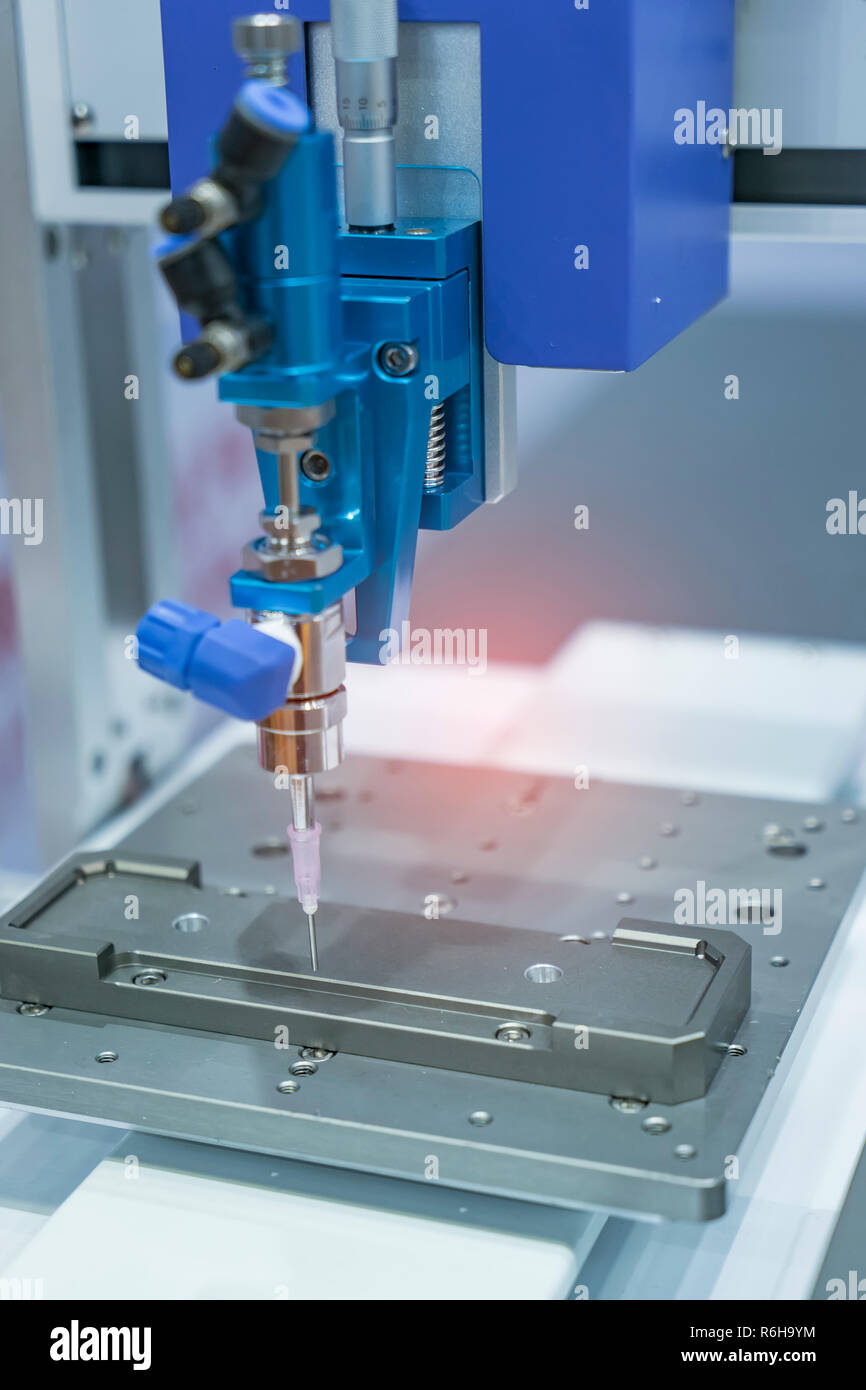 Robot holding glue syringe Injection in mobile phone factory Stock ...