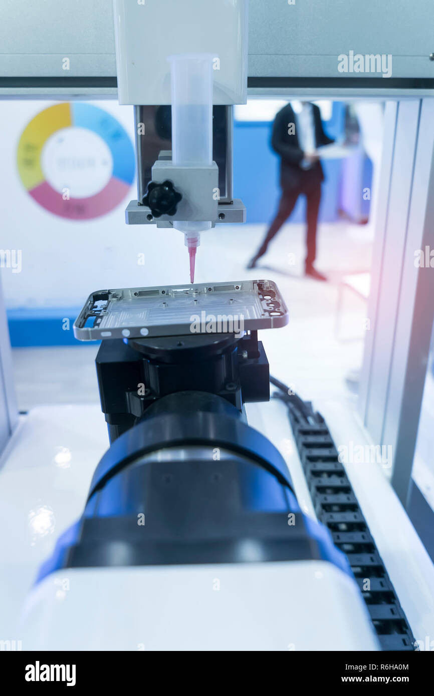 Robot holding glue syringe Injection in mobile phone factory Stock ...