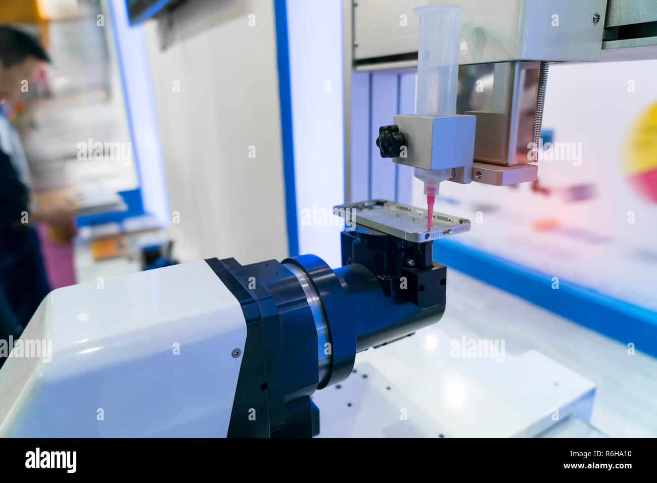 Robot holding glue syringe Injection in mobile phone factory Stock ...
