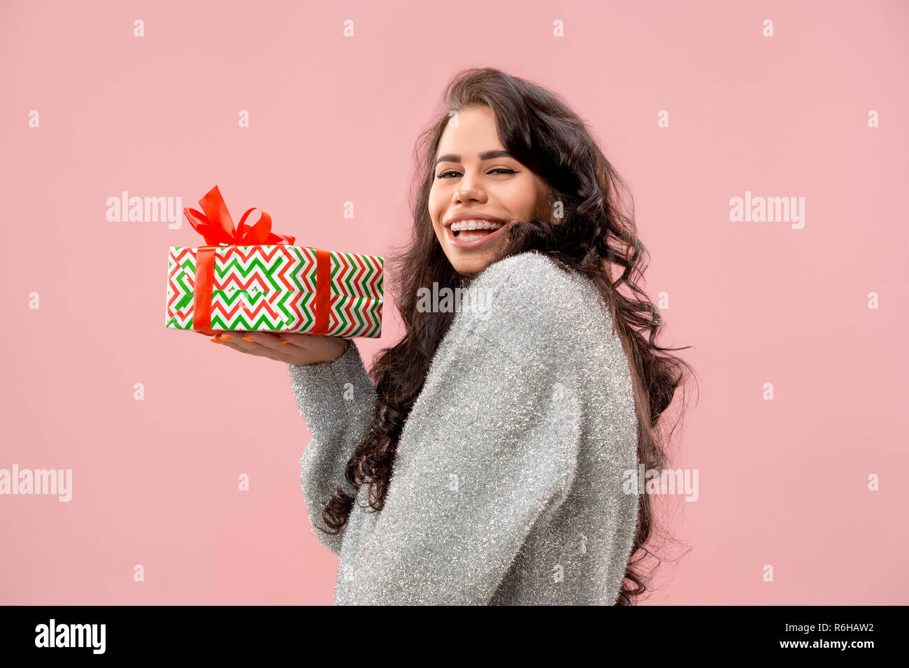 The surprised woman with big colorful gift box. Soft colors. Christmas ...