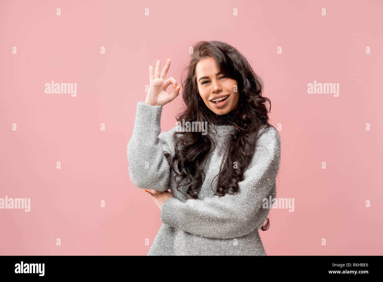 I am ok. Happy woman, sign ok, smiling, isolated on trendy pink studio ...