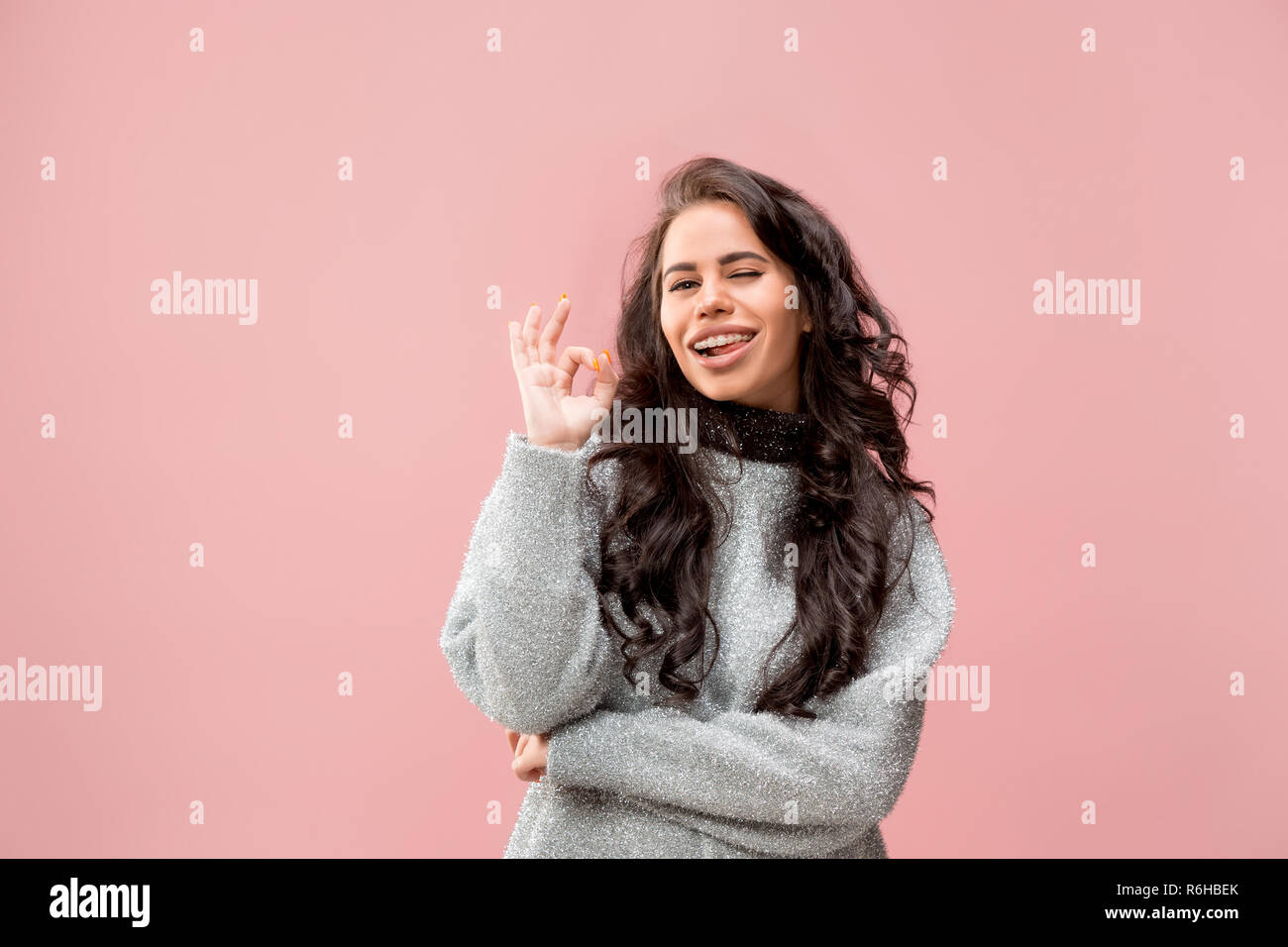 I am ok. Happy woman, sign ok, smiling, isolated on trendy pink studio ...