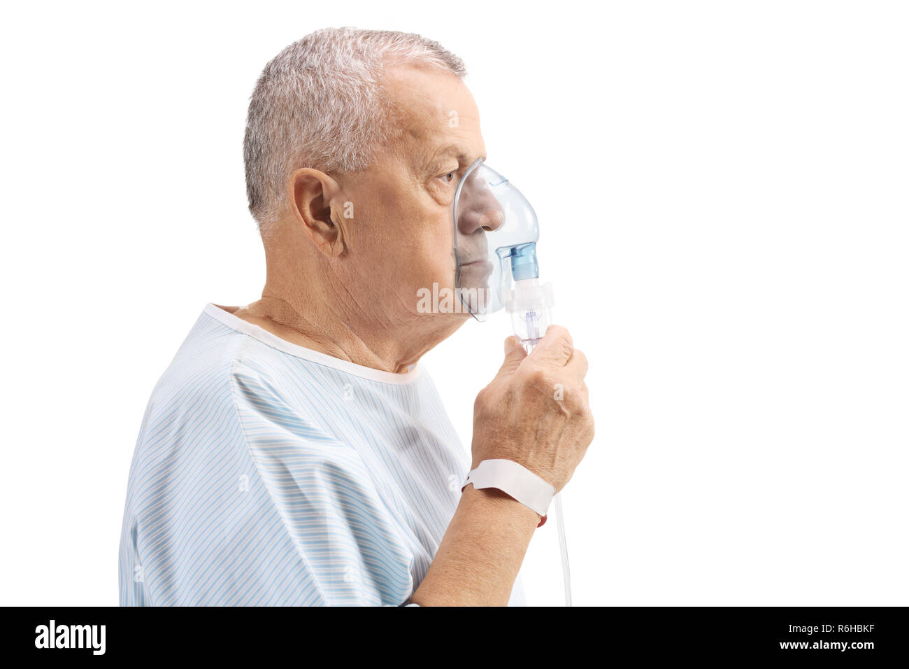 Elderly patient with an inhalation mask isolated on white background ...