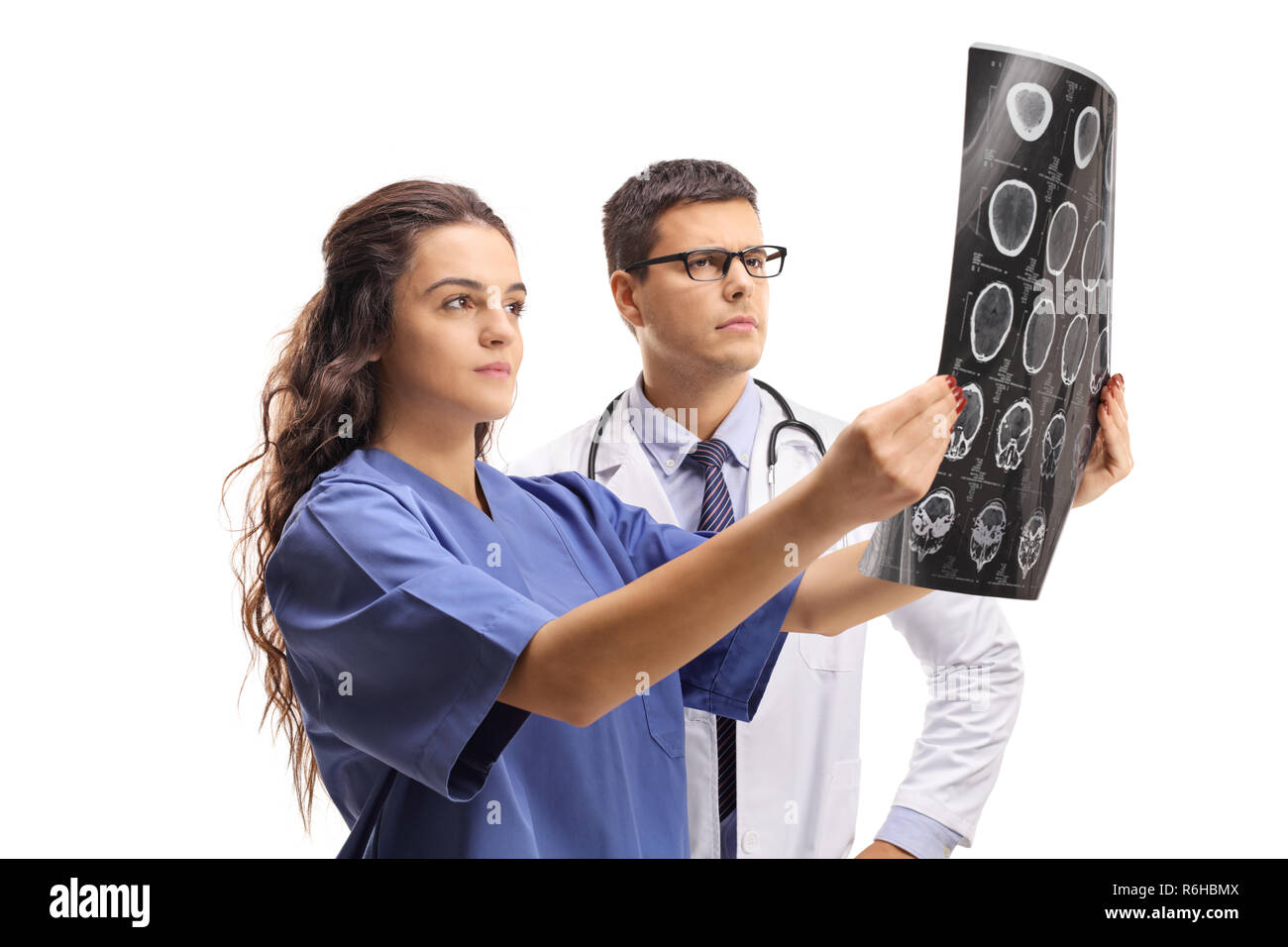 Nurse and a doctor examining an x-ray scan isolated on white background ...