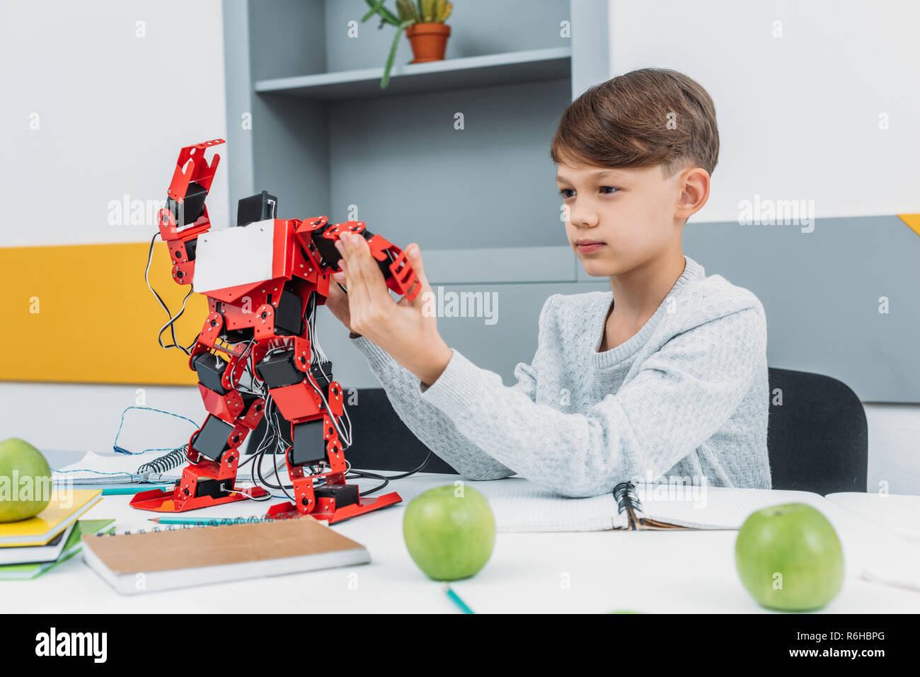 attentive boy working with a robot at STEM robotics lesson Stock Photo ...
