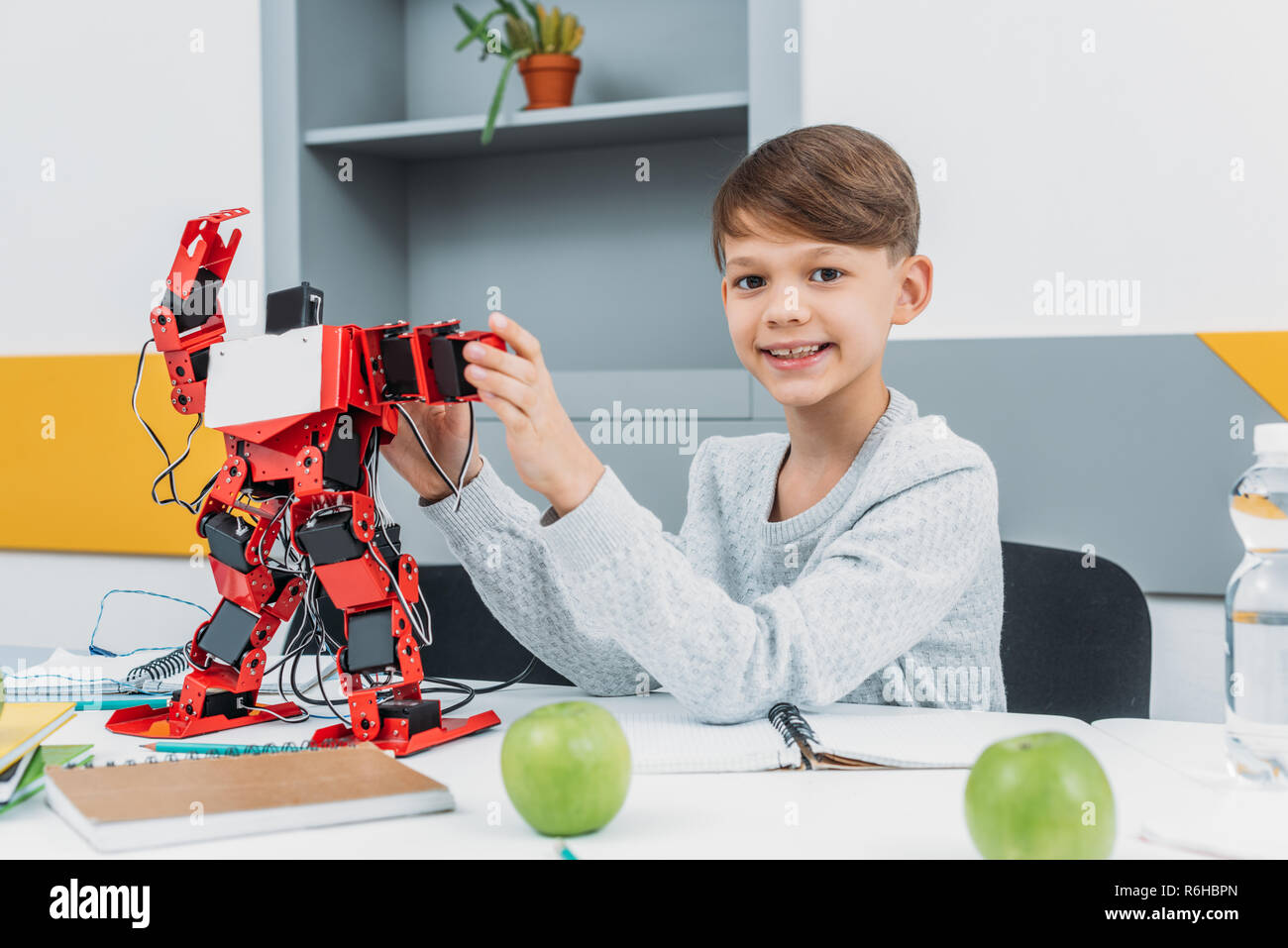 boy working with robot at STEM robotics lesson Stock Photo - Alamy