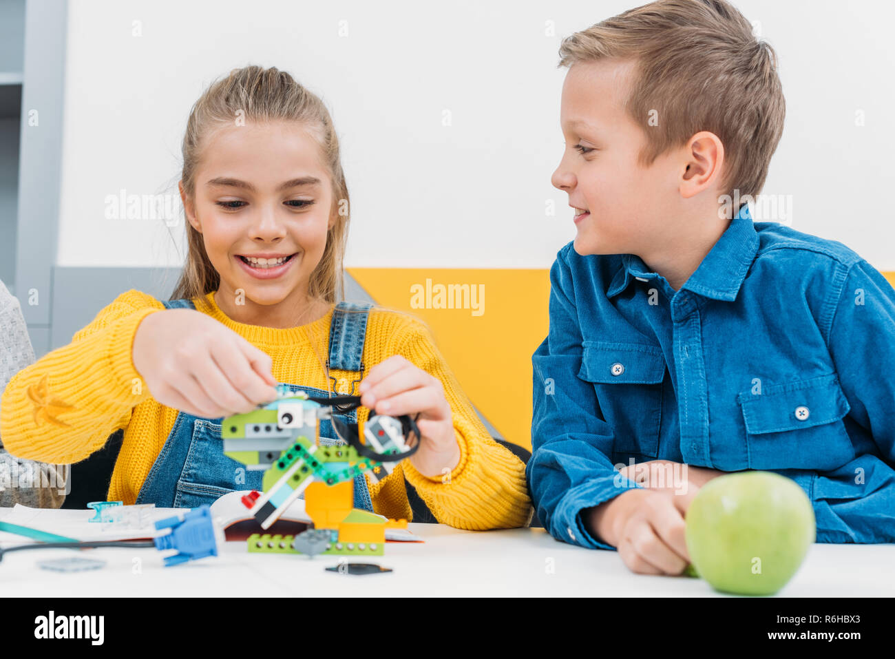 happy schoolchildren making robot with details in classroom Stock Photo ...